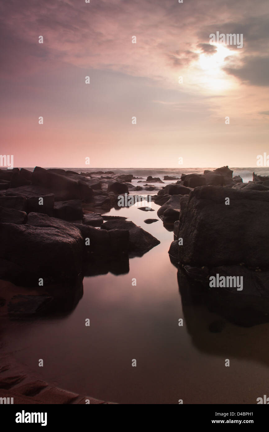 A mirror-like channel in the rocks, reflecting the warm light of the ...