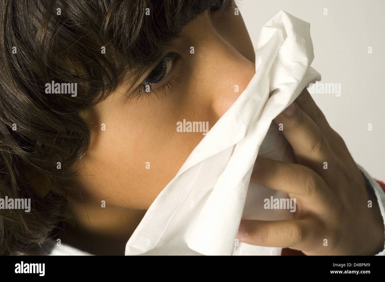 Close-up of boy blowing nose Stock Photo - Alamy