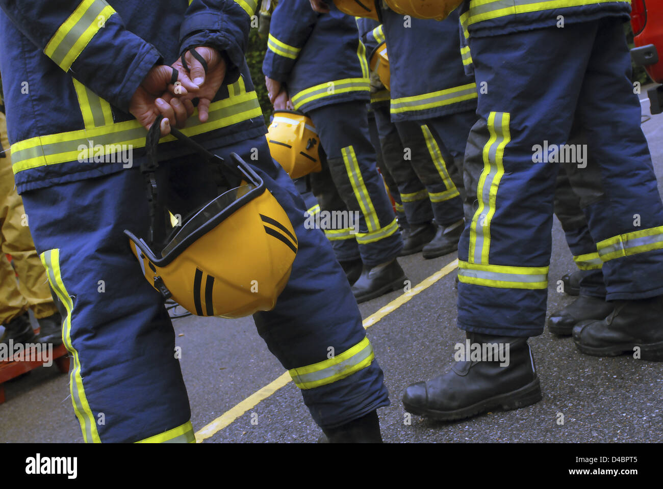 Firefighters standing on street, low section Stock Photo - Alamy