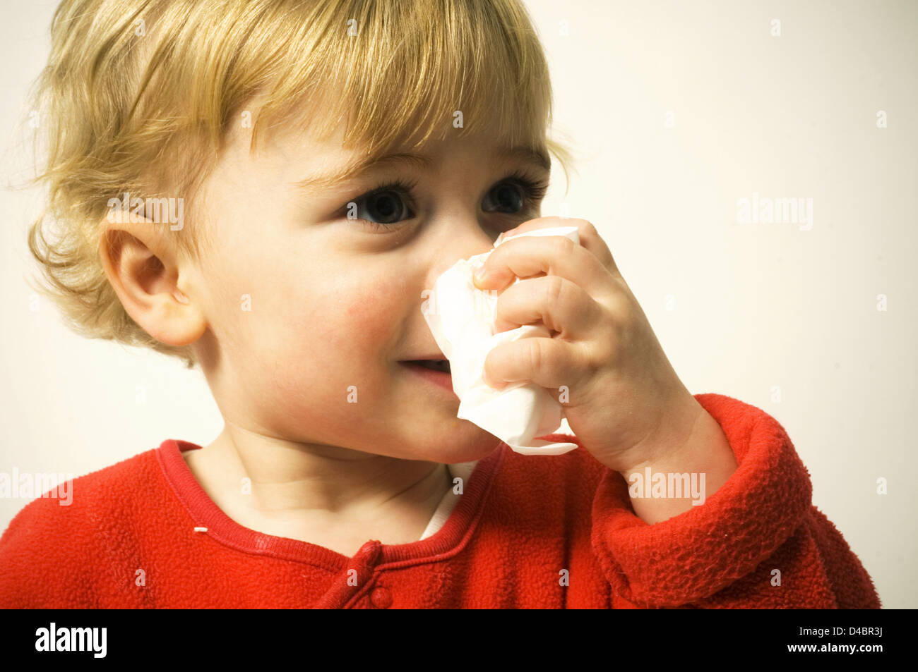 Close-up of baby boy trying blowing nose Stock Photo - Alamy