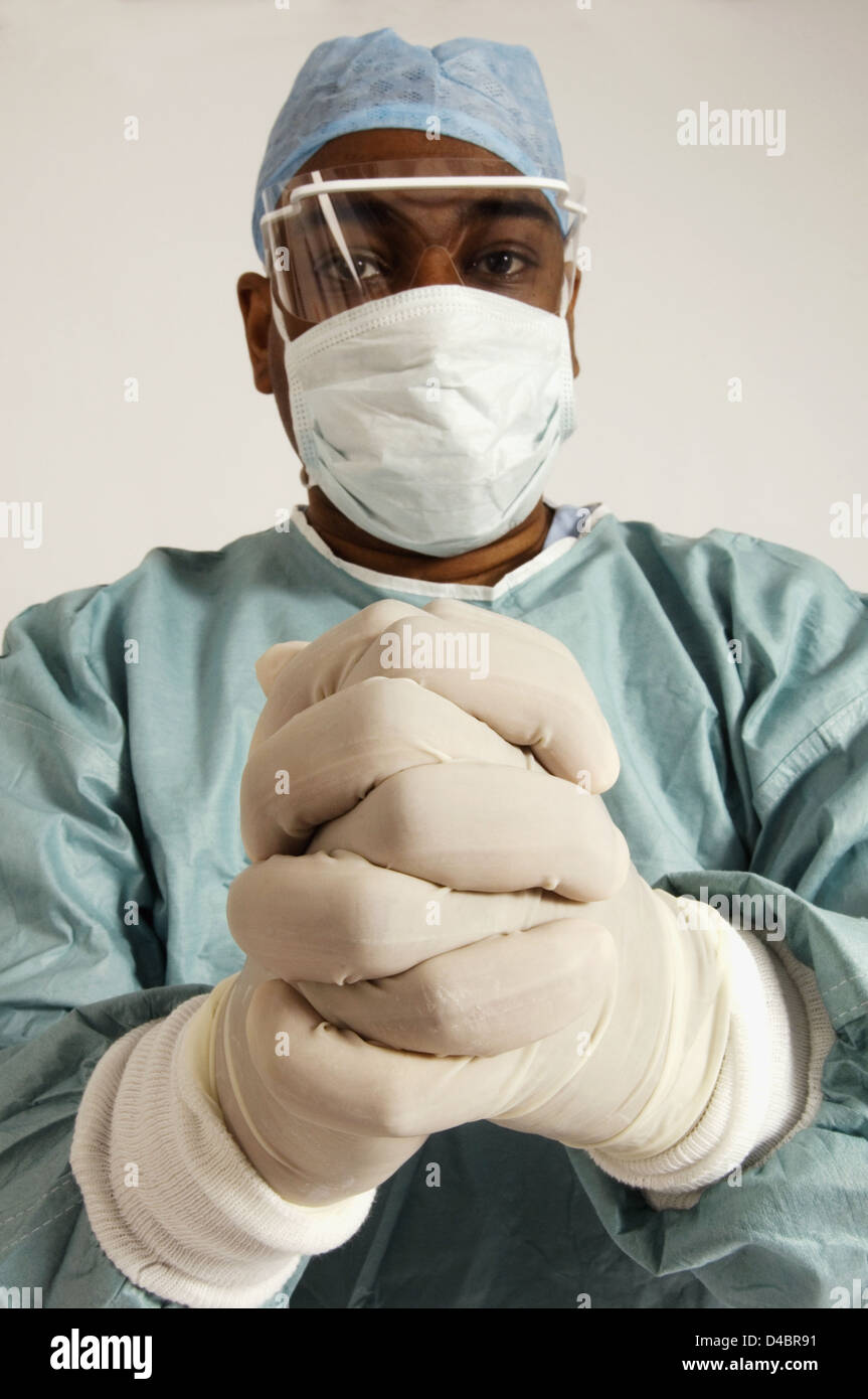 Portrait of surgeon holding out his clasped hands Stock Photo - Alamy