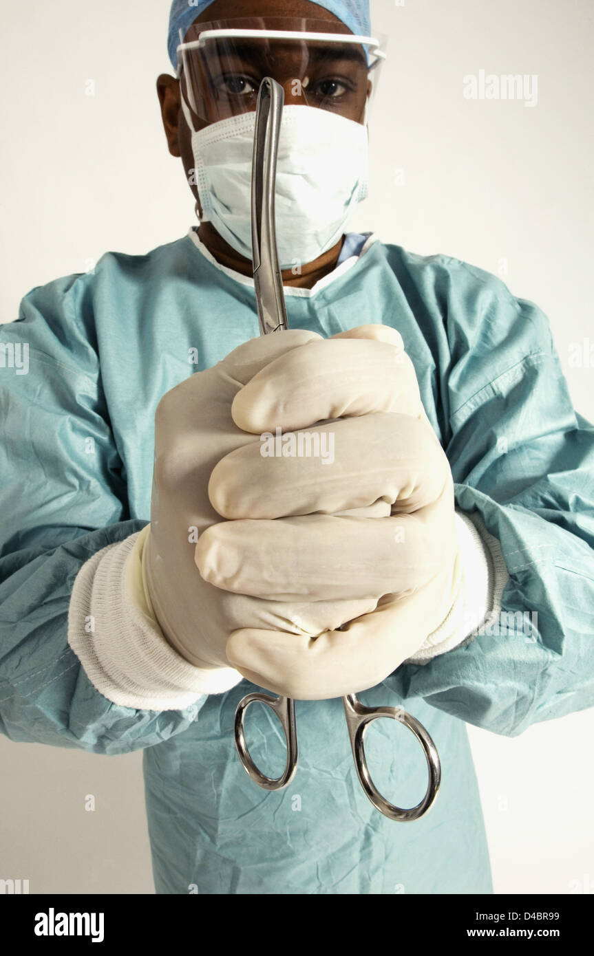Portrait of surgeon holding pair of forceps in his clasped hands Stock ...