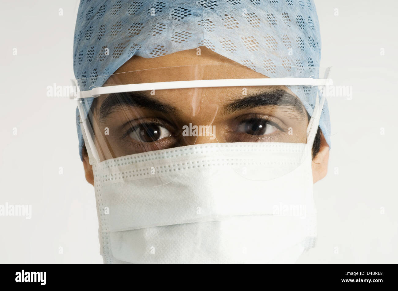 Portrait of surgeon wearing hygiene hat, hygiene mask and plastic ...