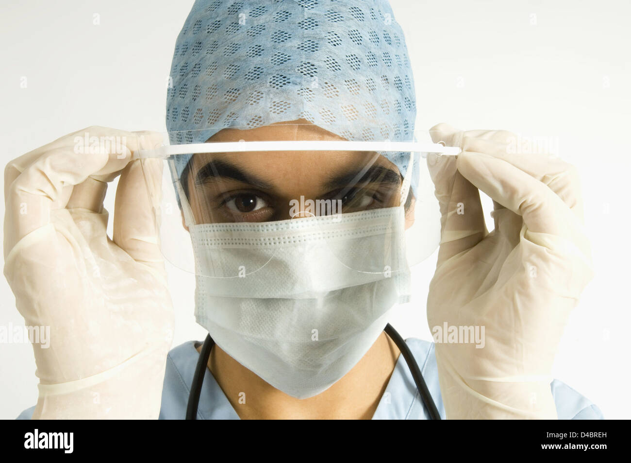 Portrait of surgeon wearing hygiene hat, hygiene mask and plastic ...
