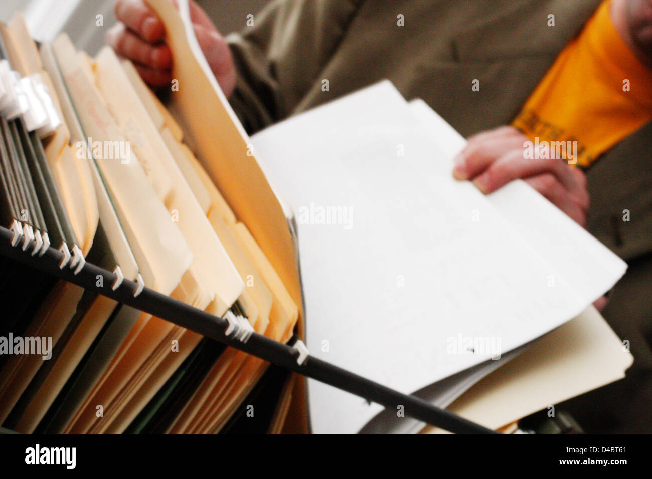 Searching through paperwork in a filing cabinet Stock Photo - Alamy