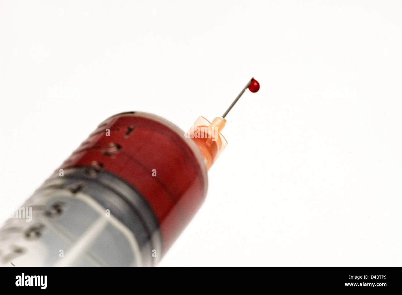 Close up of needle attached to syringe, with droplet of liquid Stock ...
