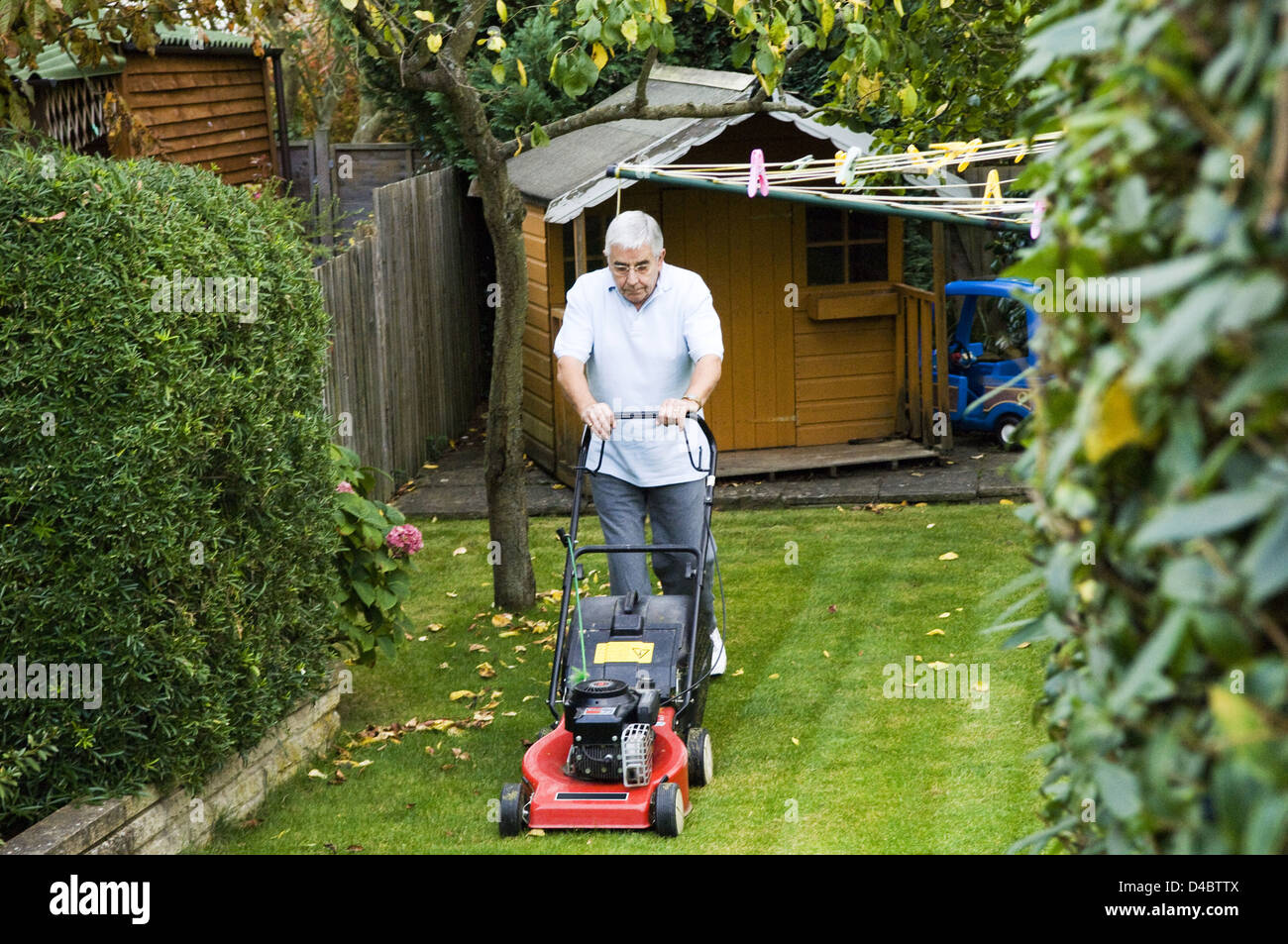 Back view man mowing grass hi-res stock photography and images - Alamy