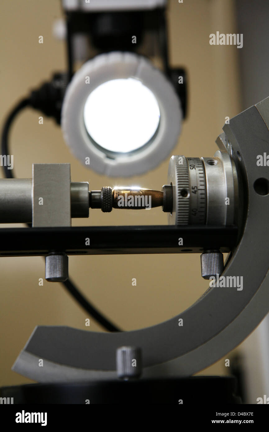 Forensic ballistic test. Crime scene bullet cartridge being examined ...