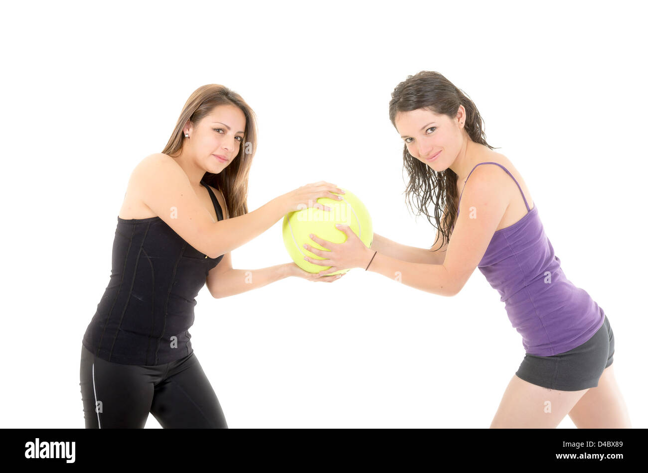 Happy women pulling a ball Stock Photo - Alamy