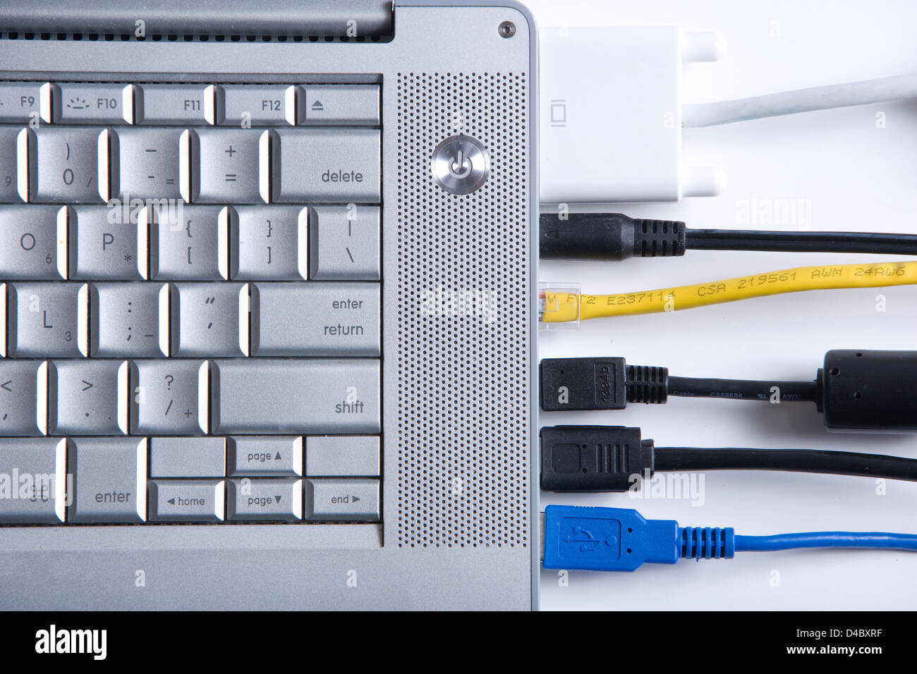 Wires connected to a modern laptop isolated on white Stock Photo - Alamy