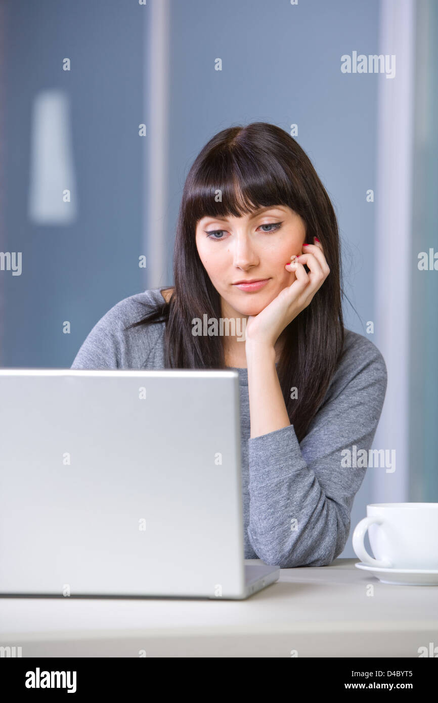 Young student using a laptop to study in a modern school or home Stock ...