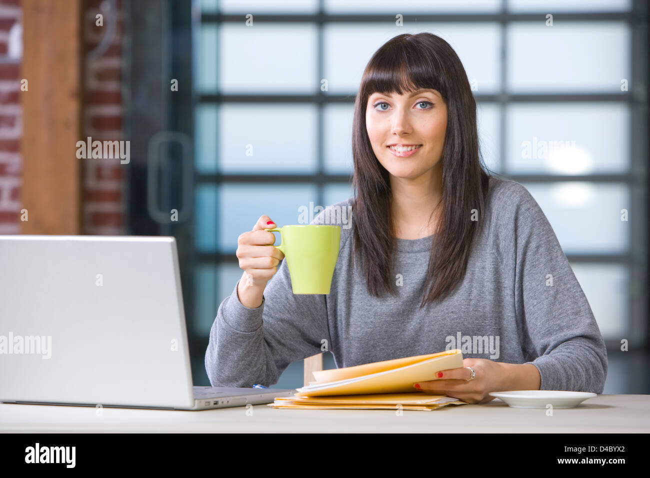 Young student using a laptop to study in a modern school or home Stock ...