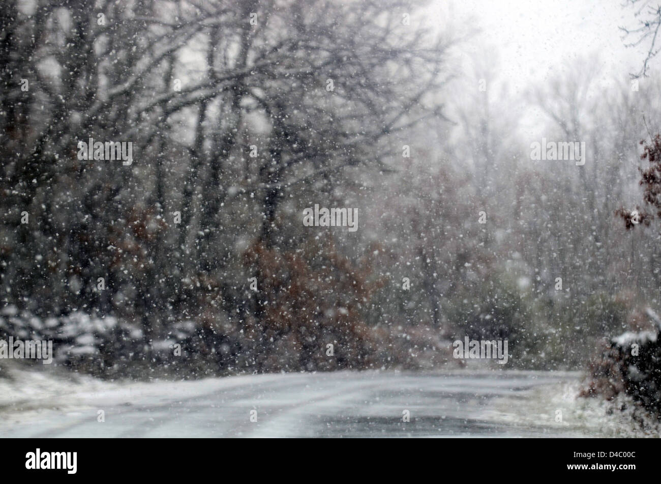 Snow falling in mountain road Stock Photo - Alamy