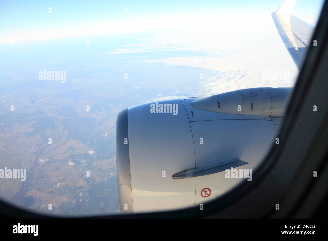 Airplane in the blue sky engine and wings white clouds Stock Photo - Alamy