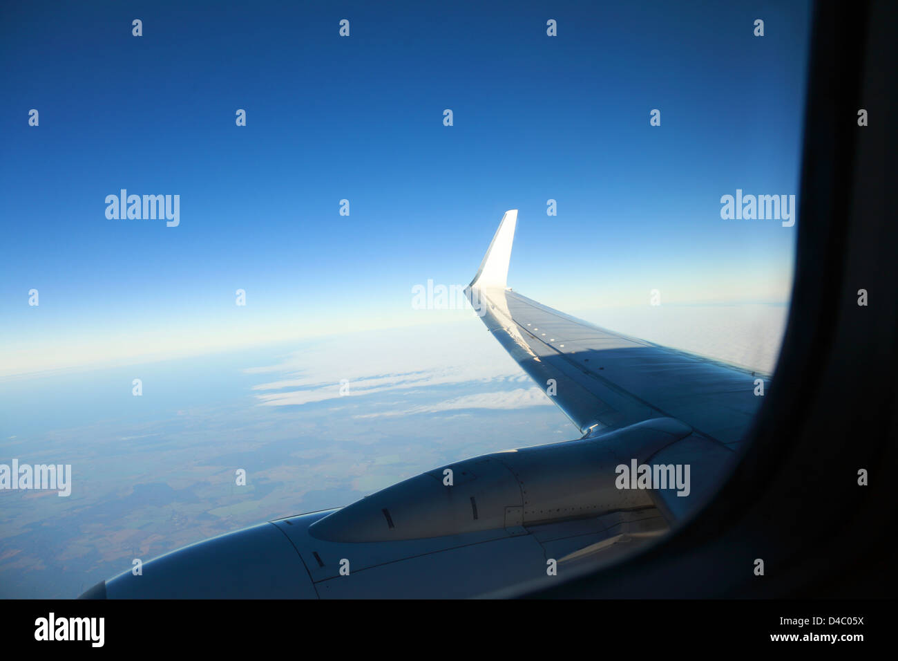 Airplane in the blue sky engine and wings white clouds Stock Photo - Alamy