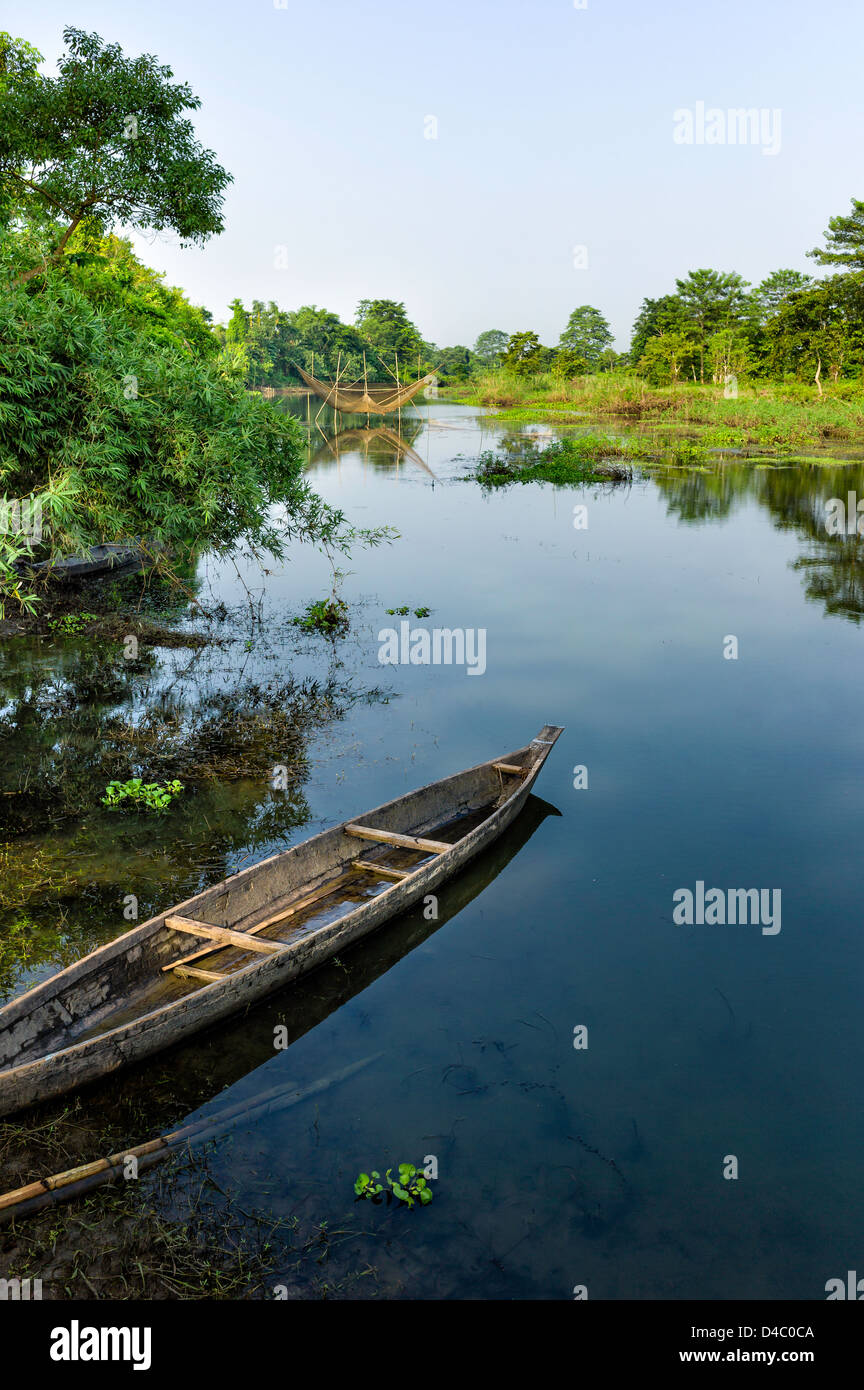 Leaking wooden boat in lagoon with Chinese fishing net in the island of ...