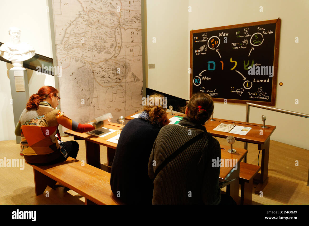 A woman in the jewish classroom exhibit in the Jewish Museum in Berlin ...