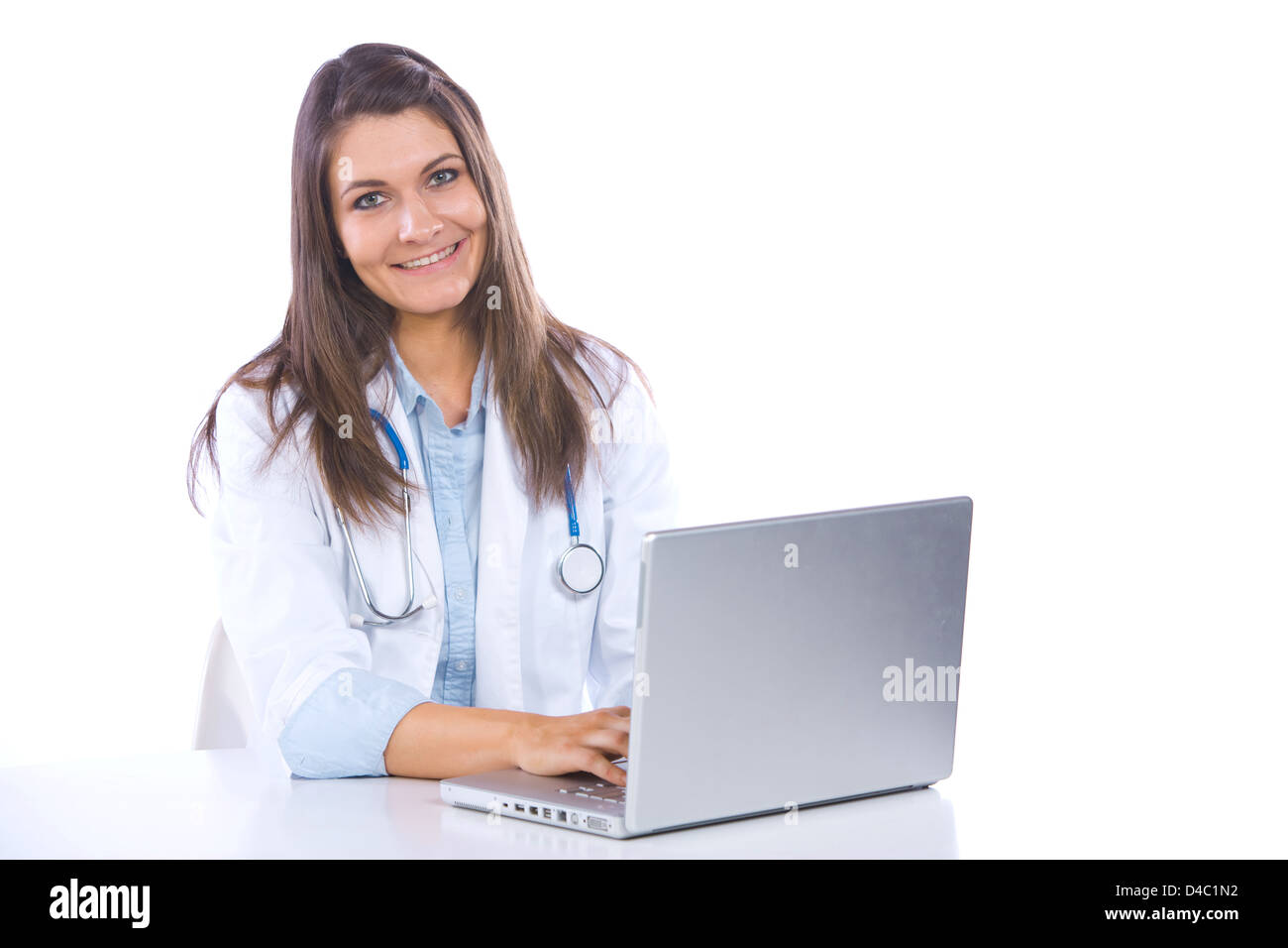 Female doctor on computer at desk isolated on white Stock Photo - Alamy