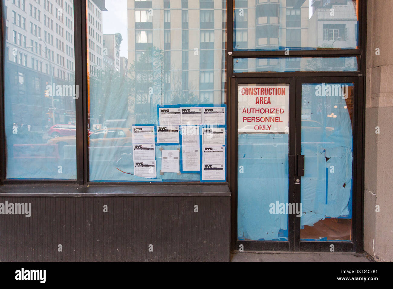 Store front closed for renovation showing NYC's permits behind the ...