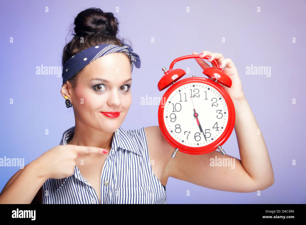 Young beautiful woman with red alarm clock blue background. Time ...