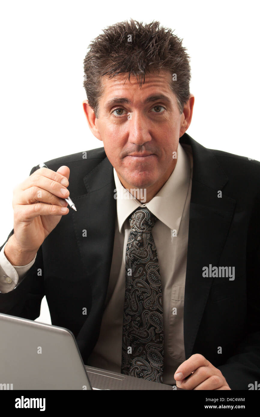 An executive sits at his laptop looking directly into the camera Stock ...