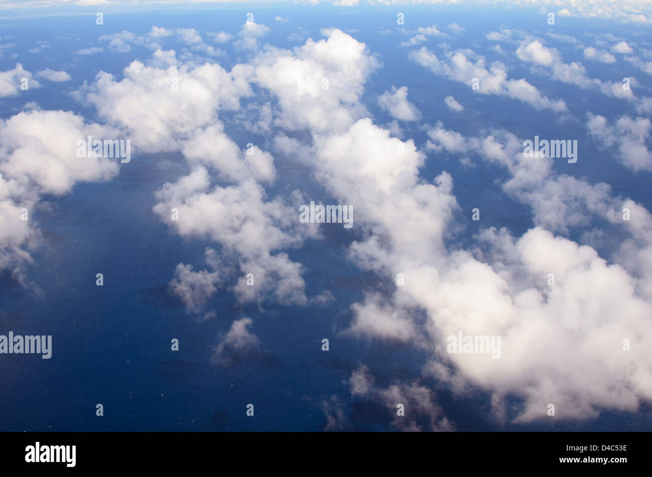 Lines of fluffy white clouds over the dark blue Pacific Ocean Stock ...