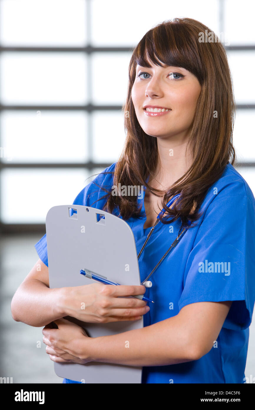Female Nurse in a modern office holding a chart Stock Photo - Alamy