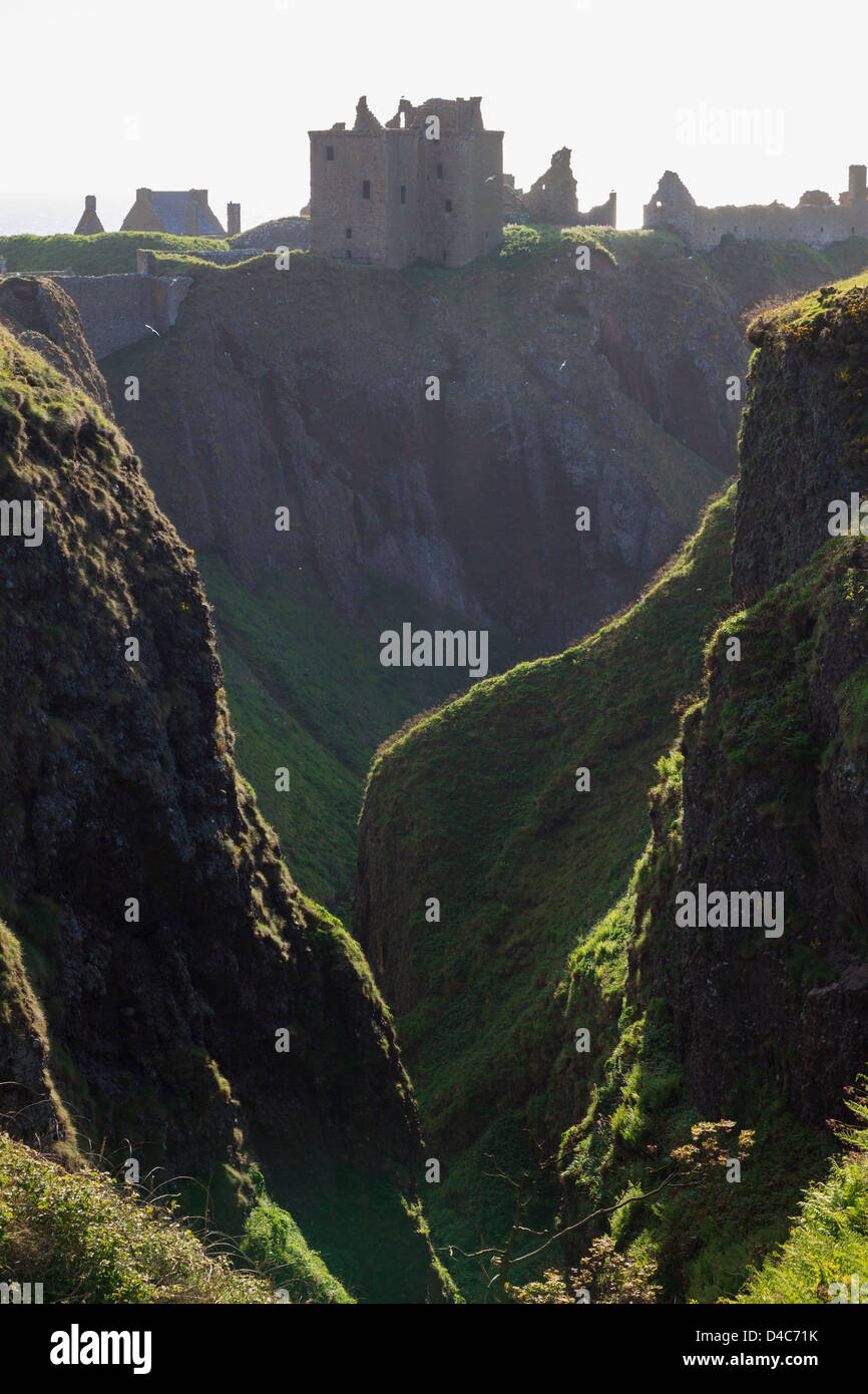 Medieval Dunnottar Castle ruins beyond a ravine on a Scottish headland ...