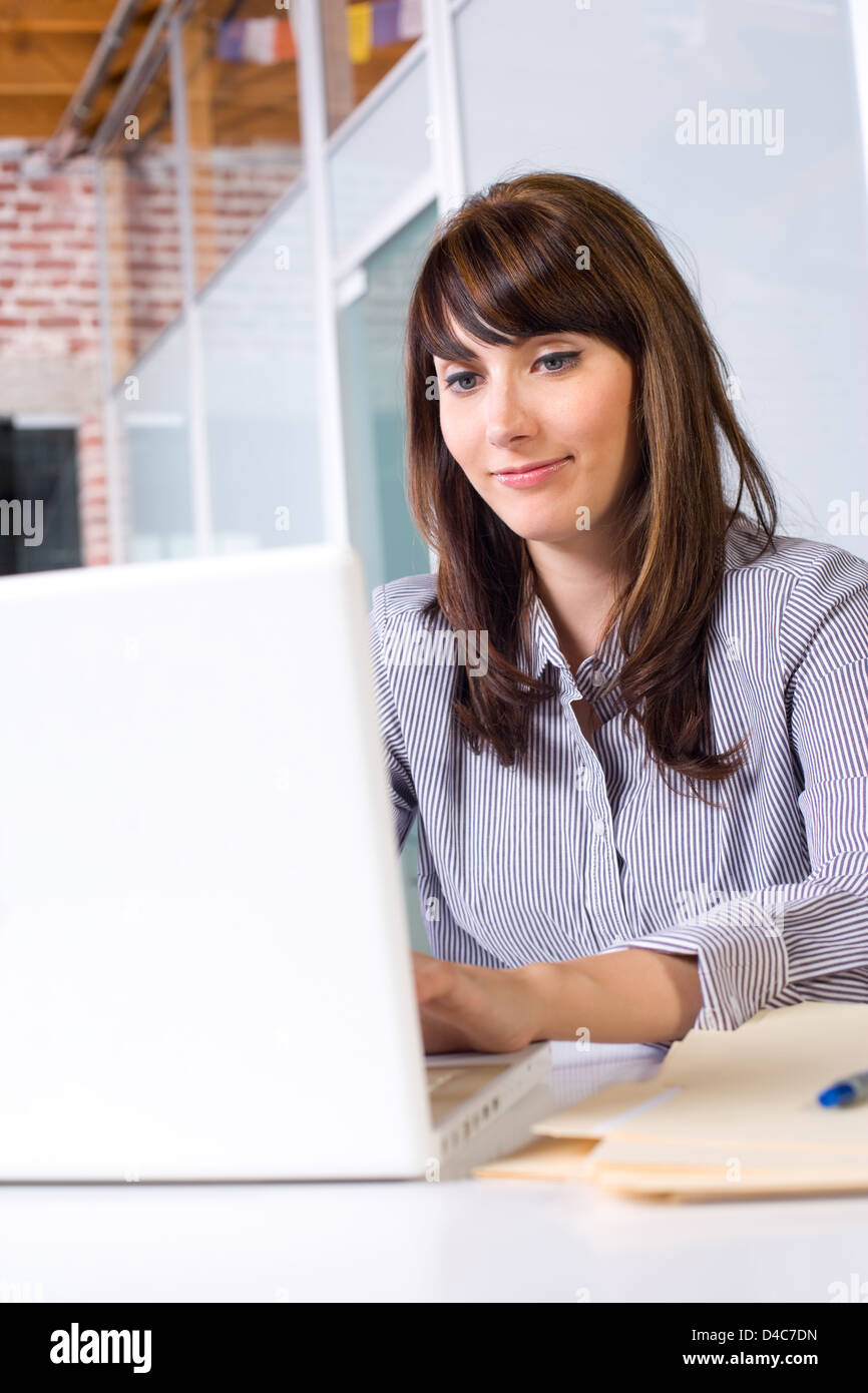 Business Woman Writing notes at desk in a modern office Stock Photo - Alamy