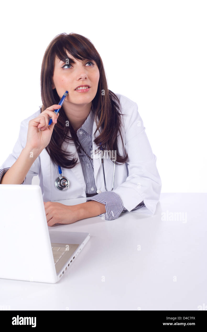 Female doctor on computer at desk isolated on white Stock Photo - Alamy