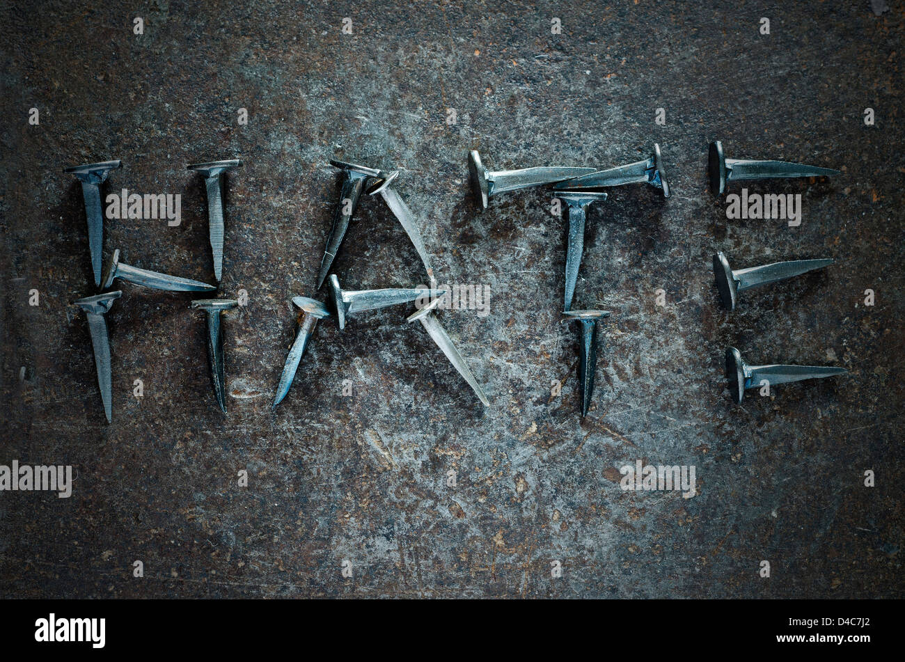 The word "HATE" written with studs on a metal background Stock Photo ...