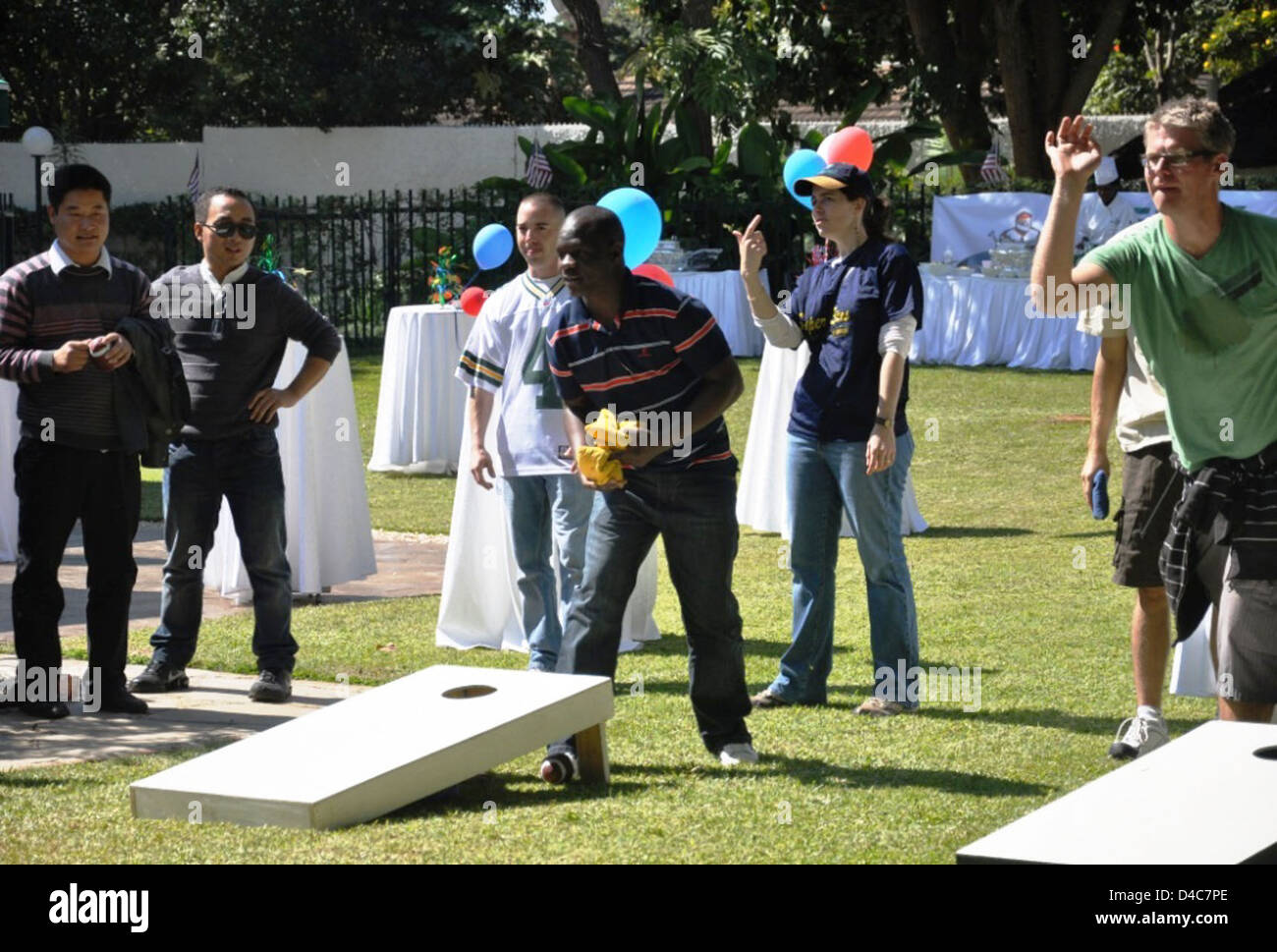 Americans and Zambians Compete in a Bean Bag Toss Contest Stock Photo ...