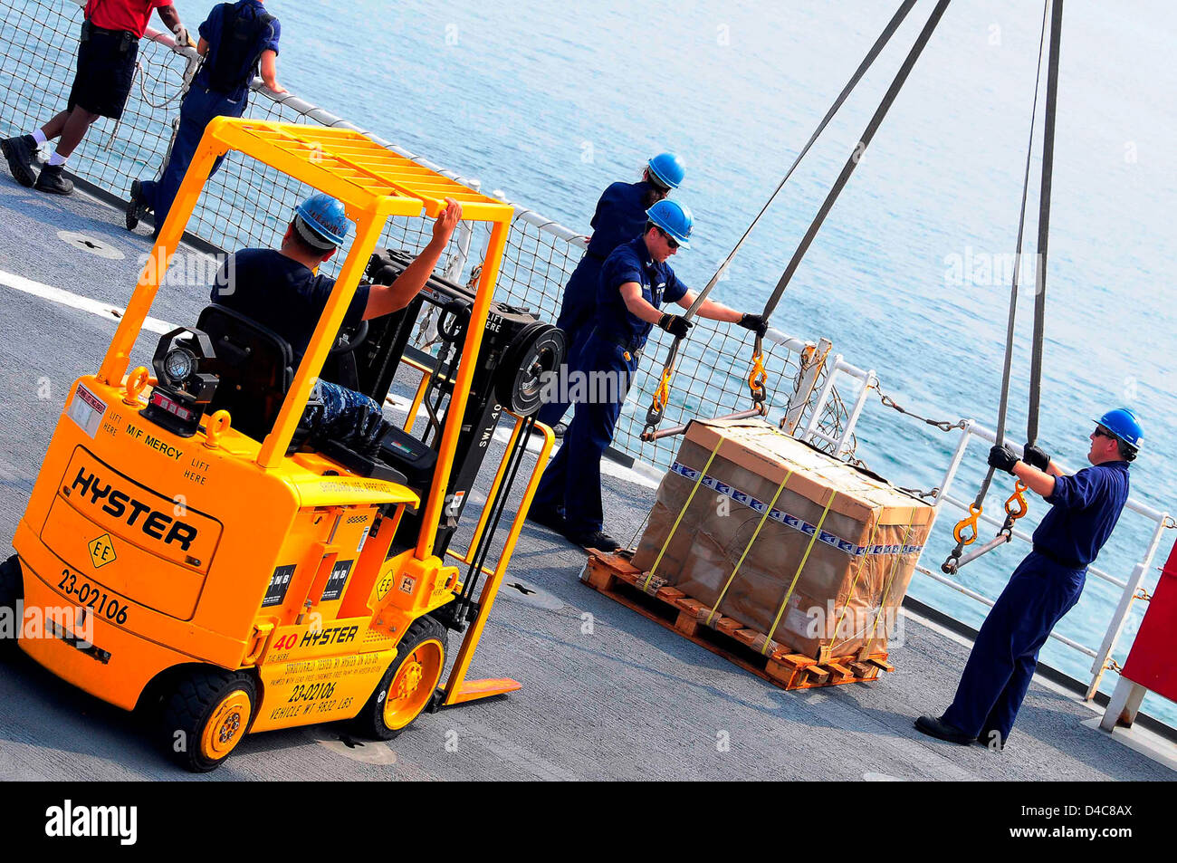 Sailors Remove Crane-Securing Straps From a Pallet of Medical Supplies ...
