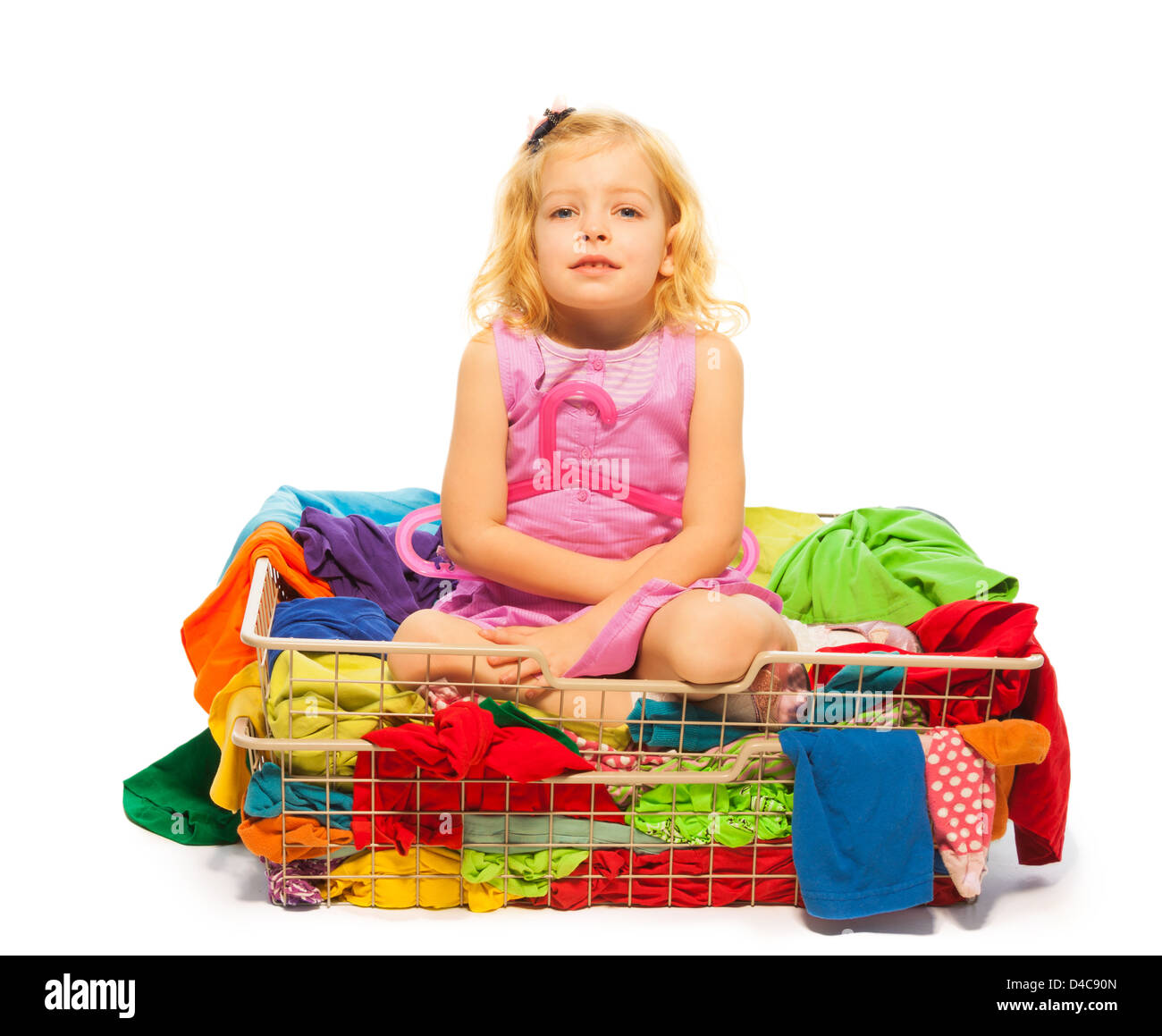 Sad little blond girl want more clothes even sitting in basket full of ...