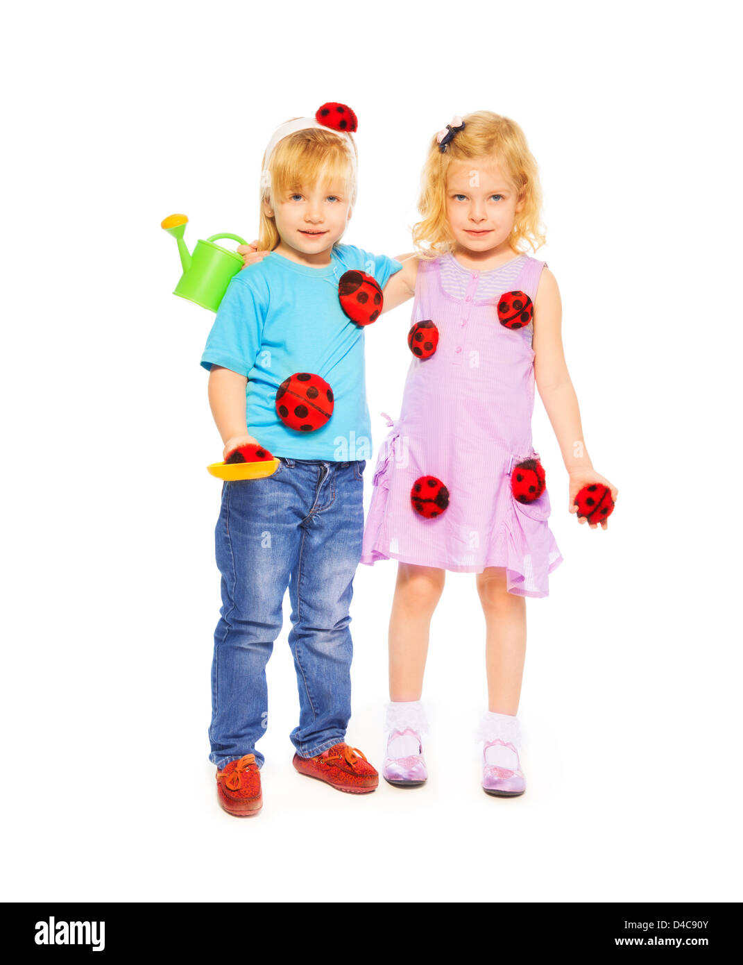 Two spring little blond girls friends standing together holding ...