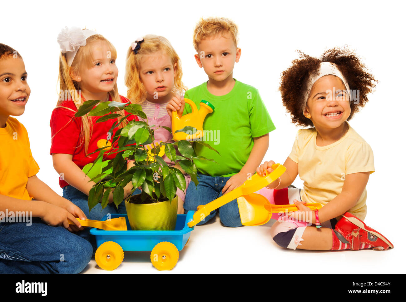 Group of kids playing on planting green spring tree sitting with ...