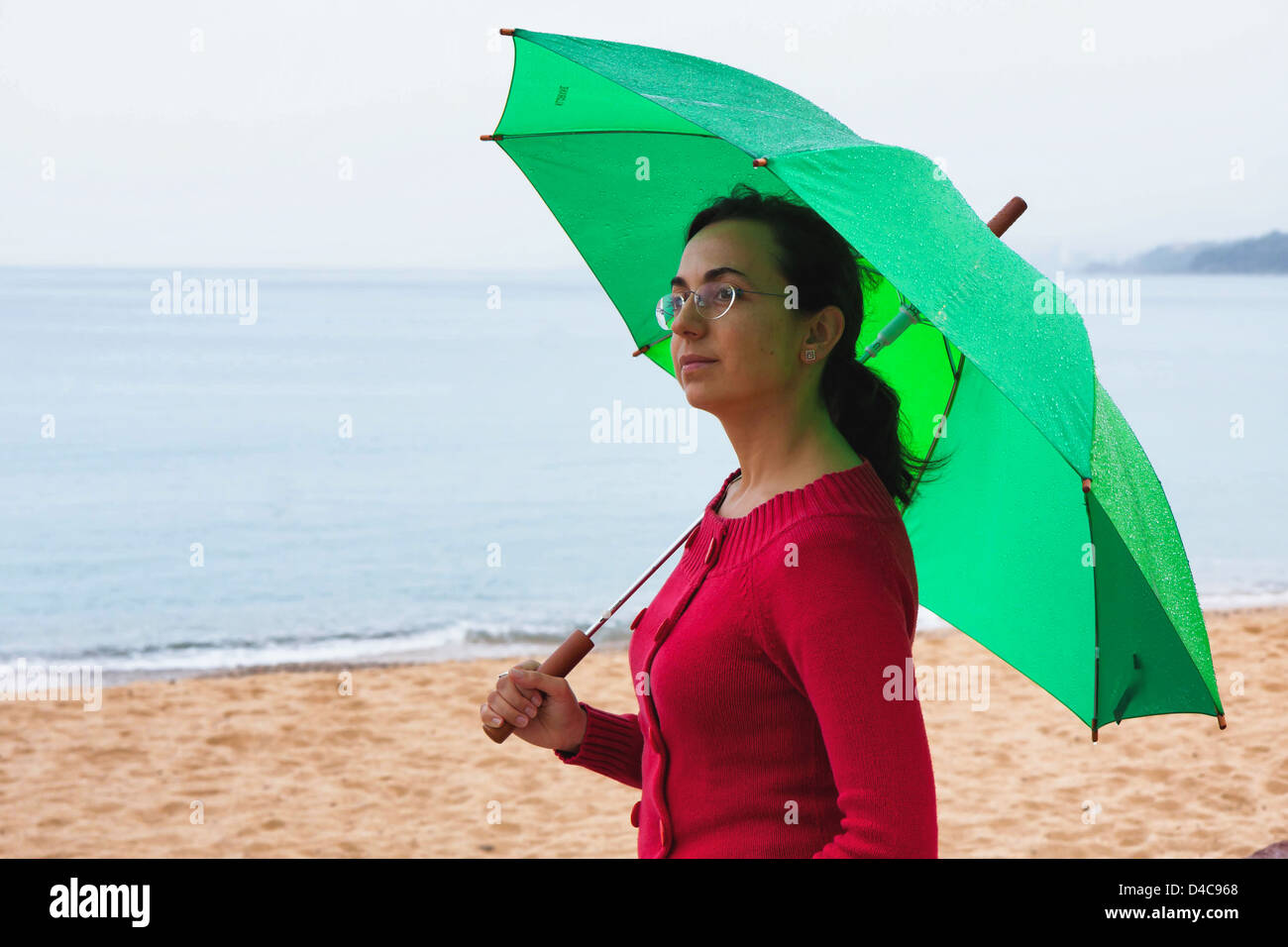 Woman beach umbrella rain hi-res stock photography and images - Alamy