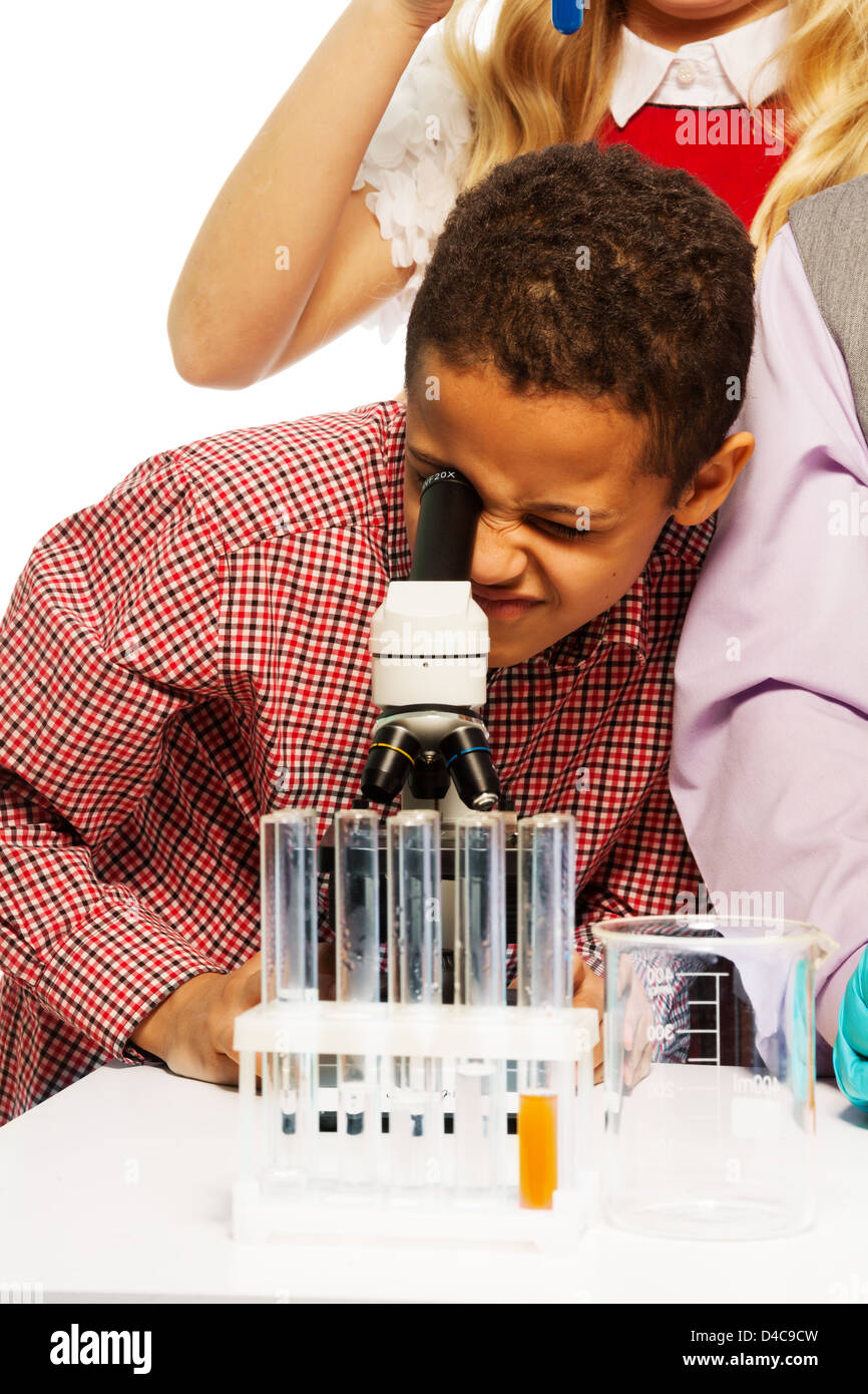 School chemistry research - black eight years old boy looking to ...