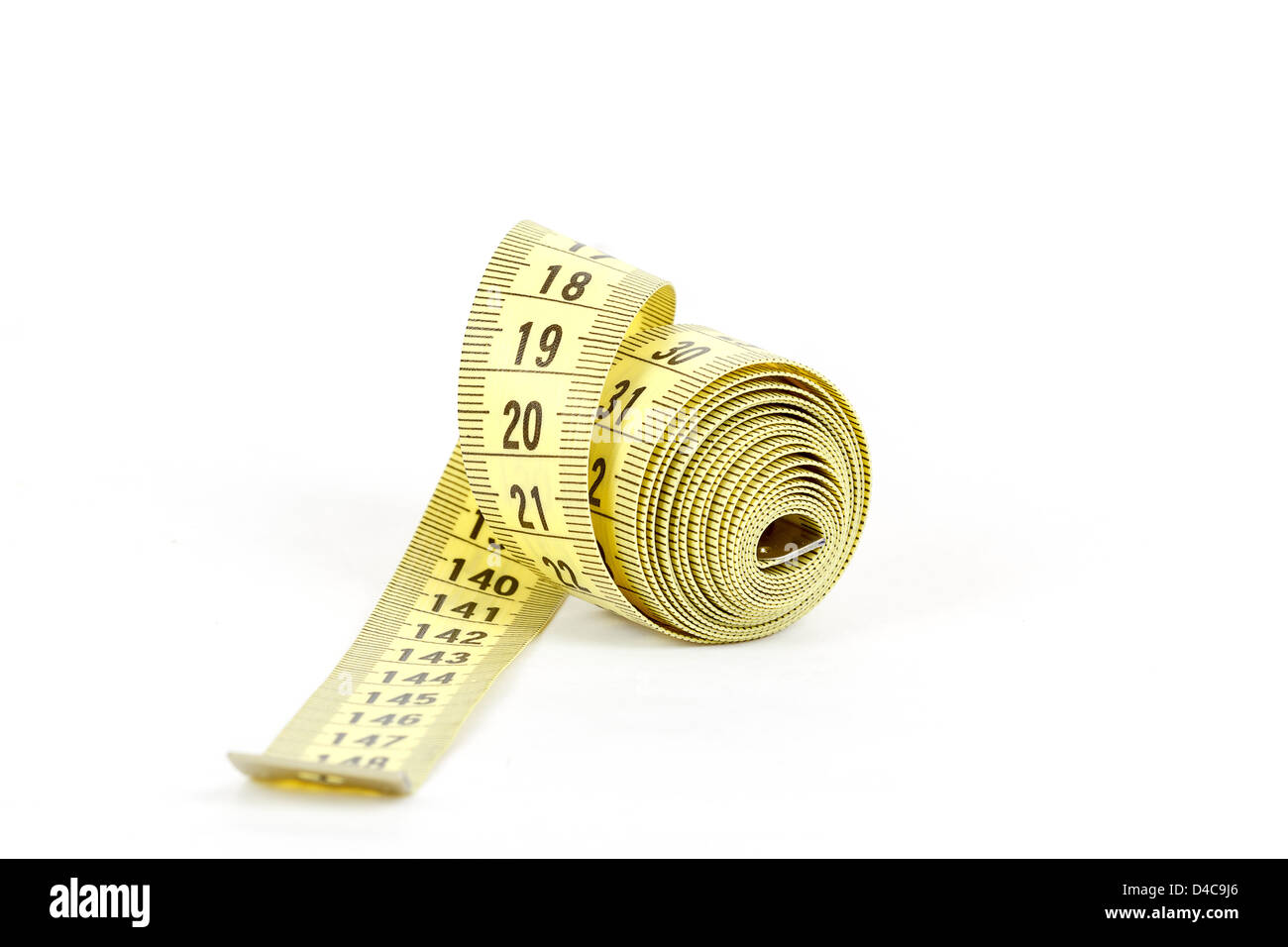 Yellow measuring tape isolated on white background Stock Photo - Alamy