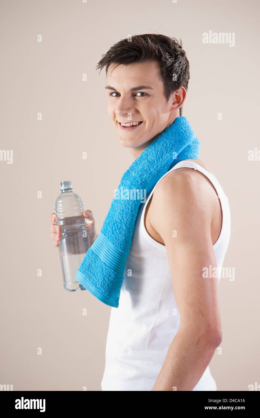 young smiling man with a water bottle Stock Photo - Alamy
