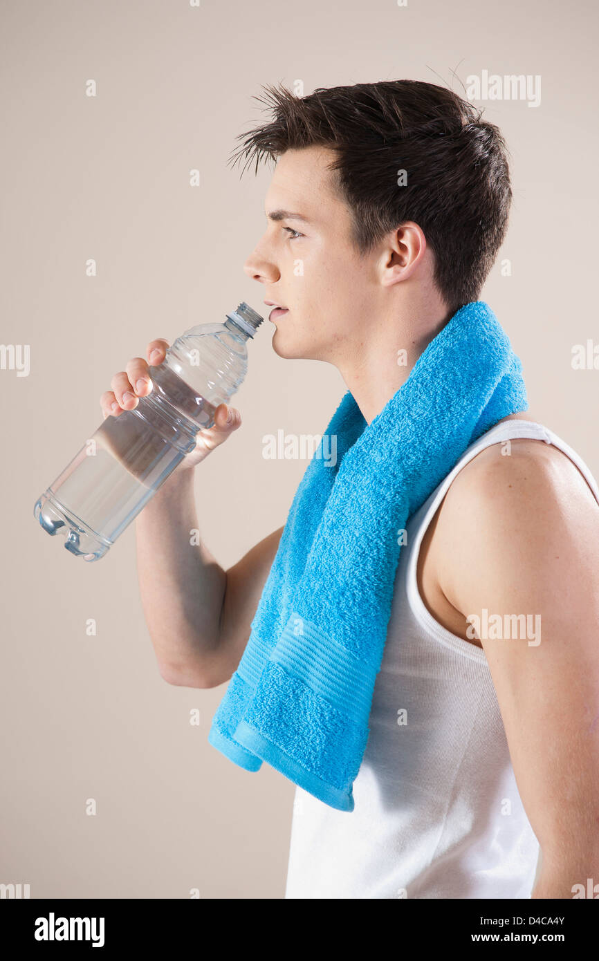 young man drinking from a water bottle Stock Photo - Alamy