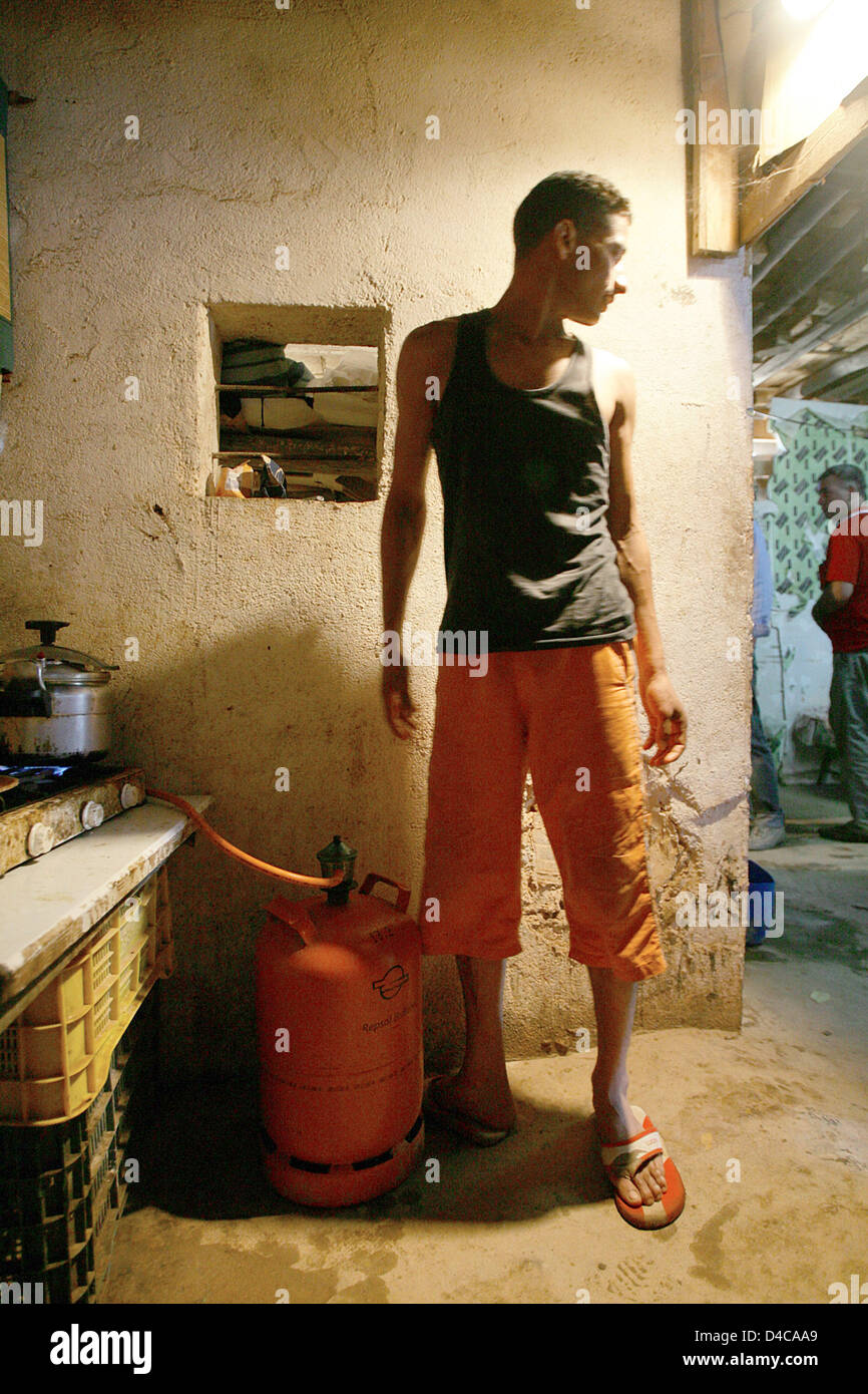 25-year-old Aziz from Morocco stands in the cooking area of a run down ...