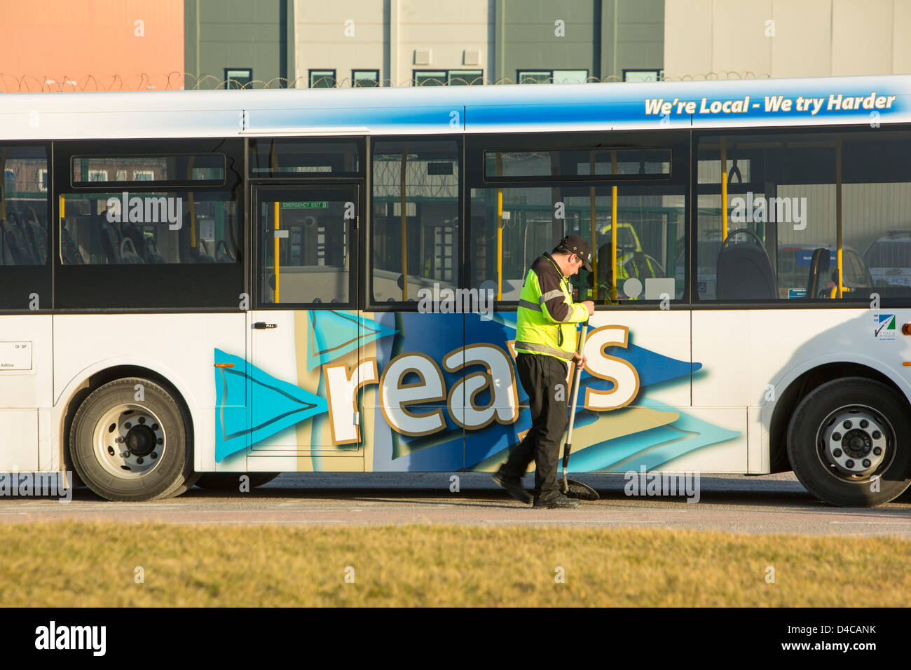 A security guard uses a mirror to checks the underside of a coach for ...