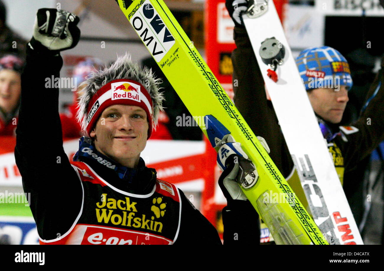 The Finnish overall winner Janne Ahonen (R) cheers on the podium with ...