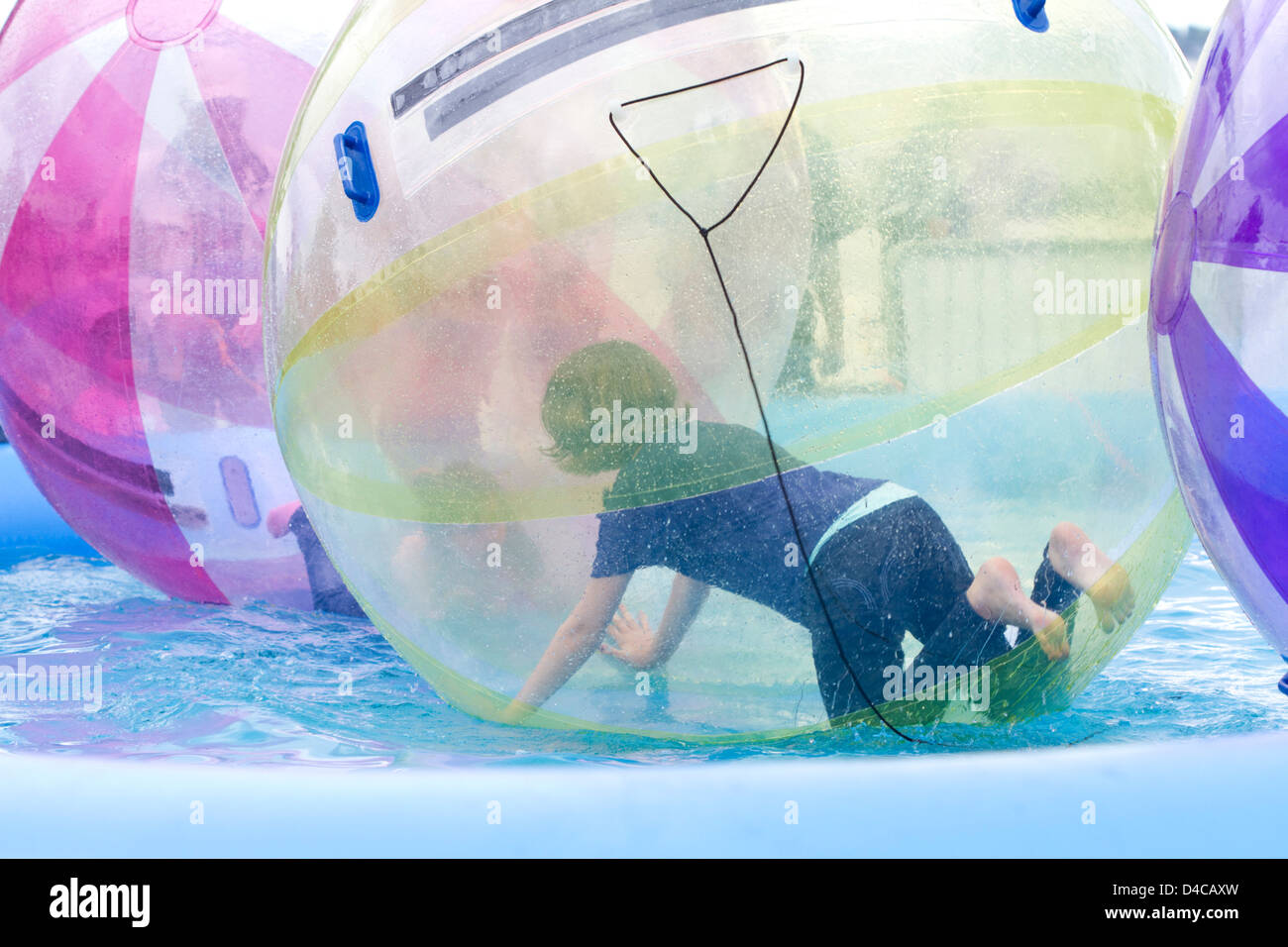 Child inside ball in water Stock Photo - Alamy