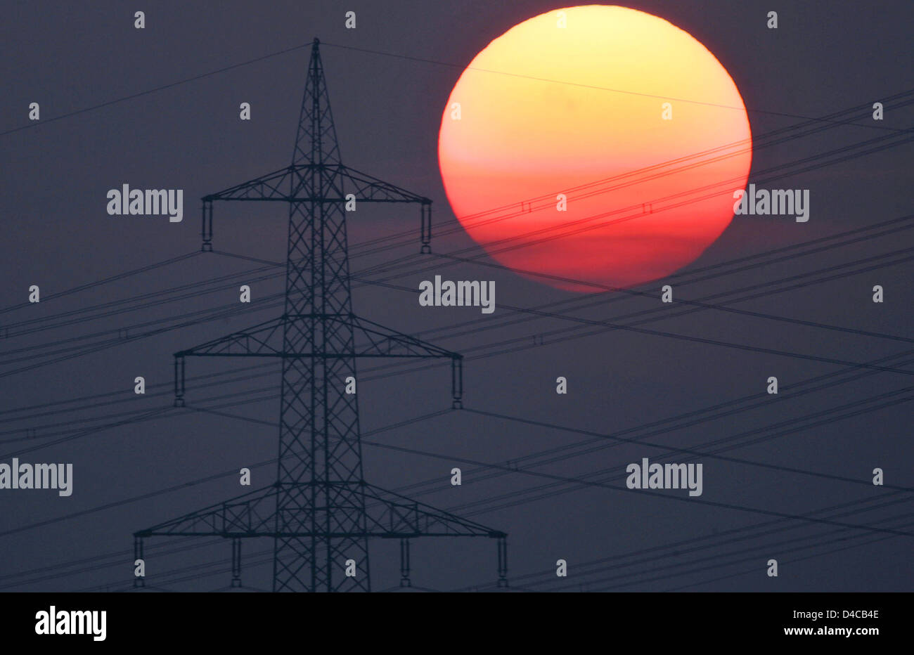A utility pole pictured with the rising sun in Darmstadt, Germany ...