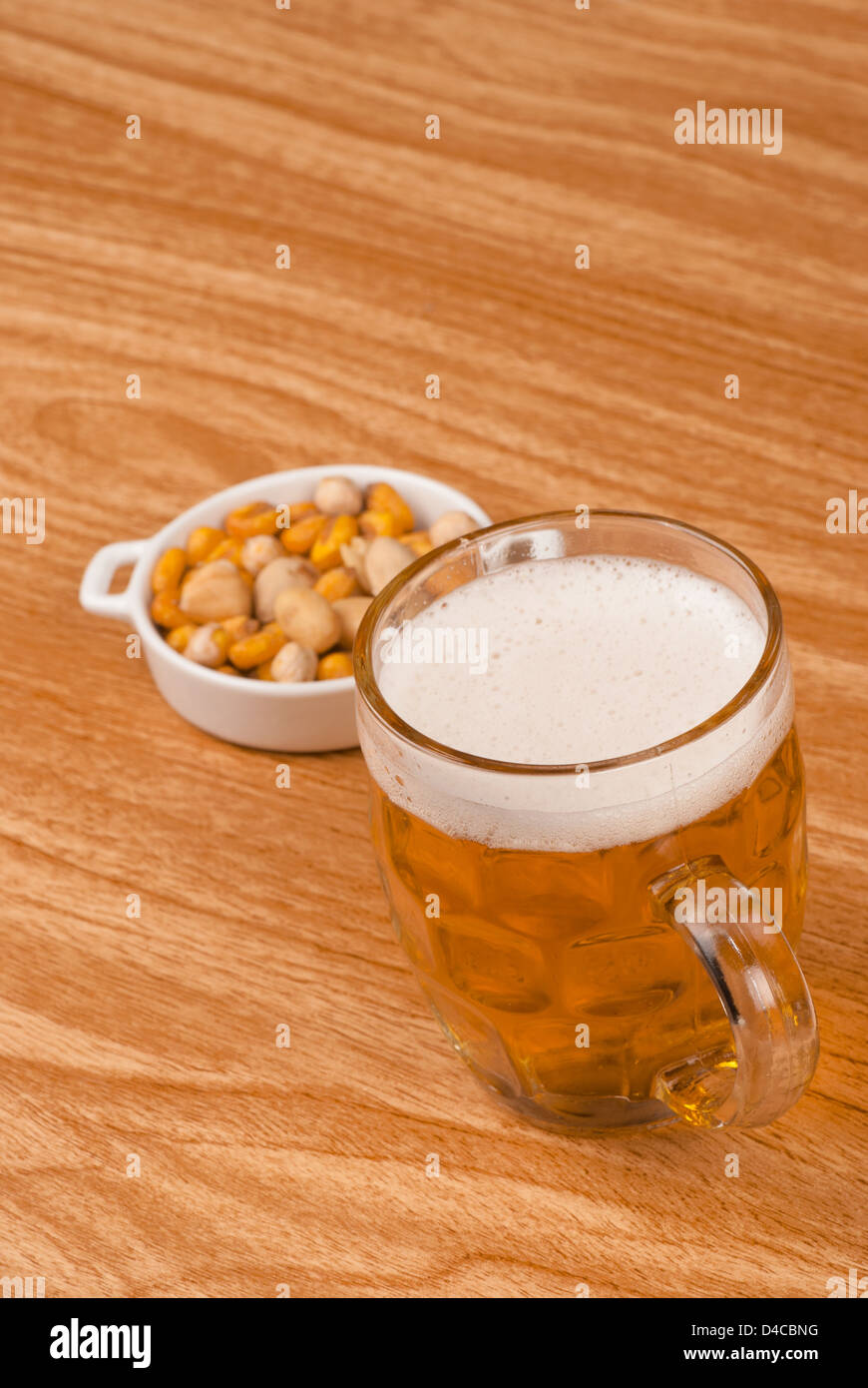 Beer on bar counter with a crunchy appetizer Stock Photo - Alamy