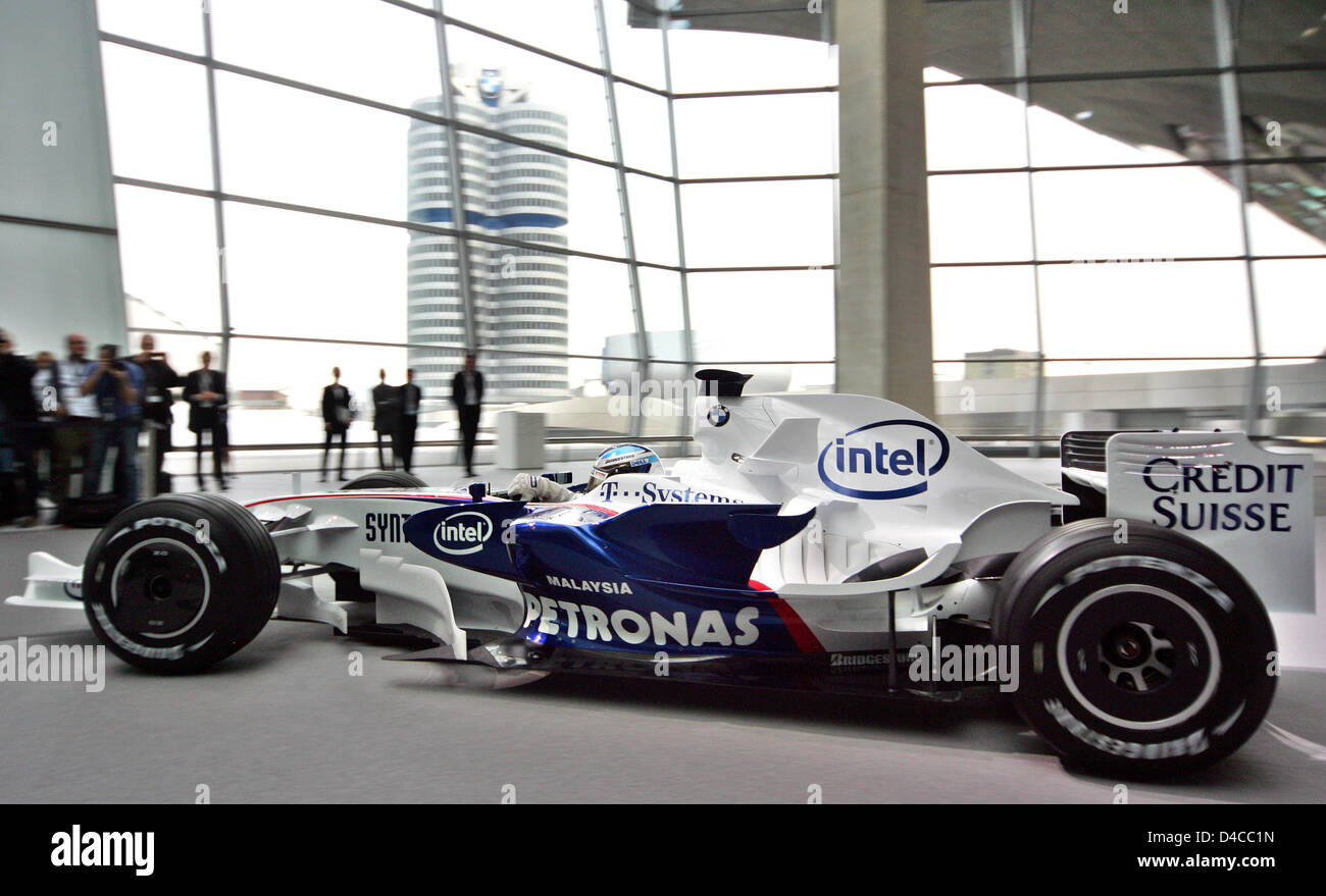 Formula One driver Nick Heidfeld (R) from Germany drives through the ...