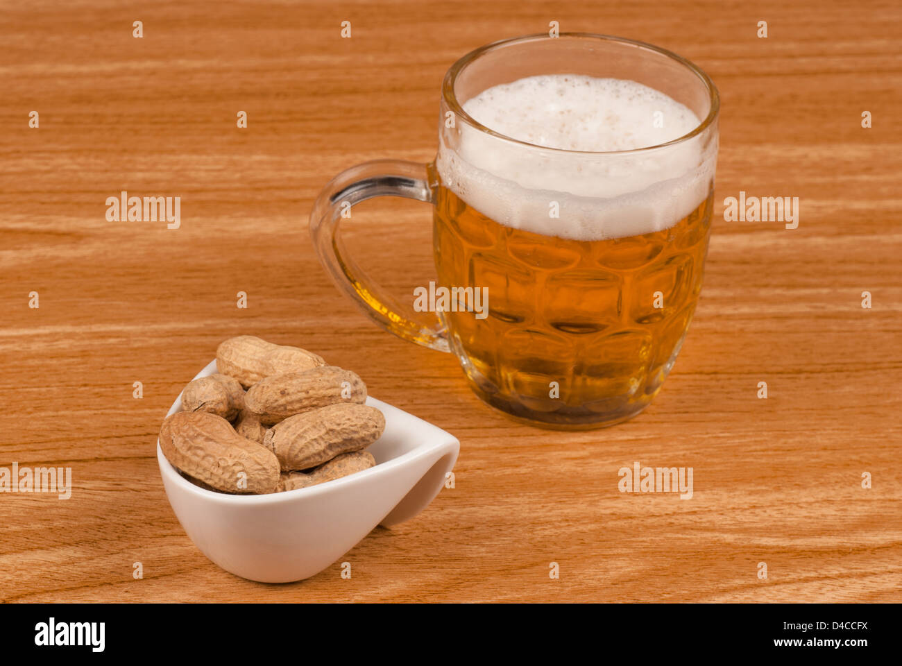 Beer and peanuts on a wooden bar counter Stock Photo - Alamy