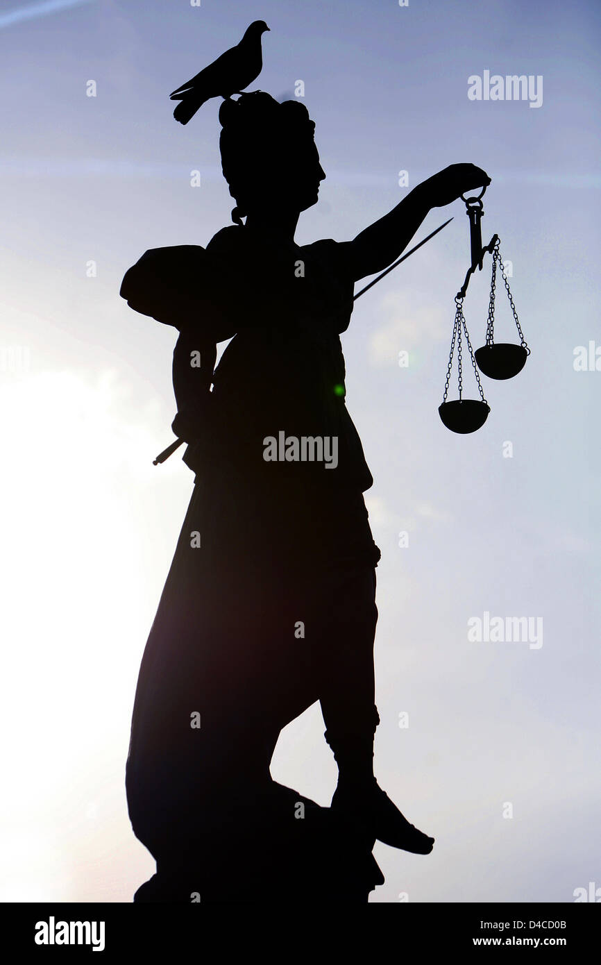 The picture shows a statue of the Roman goddess of justice on the ...